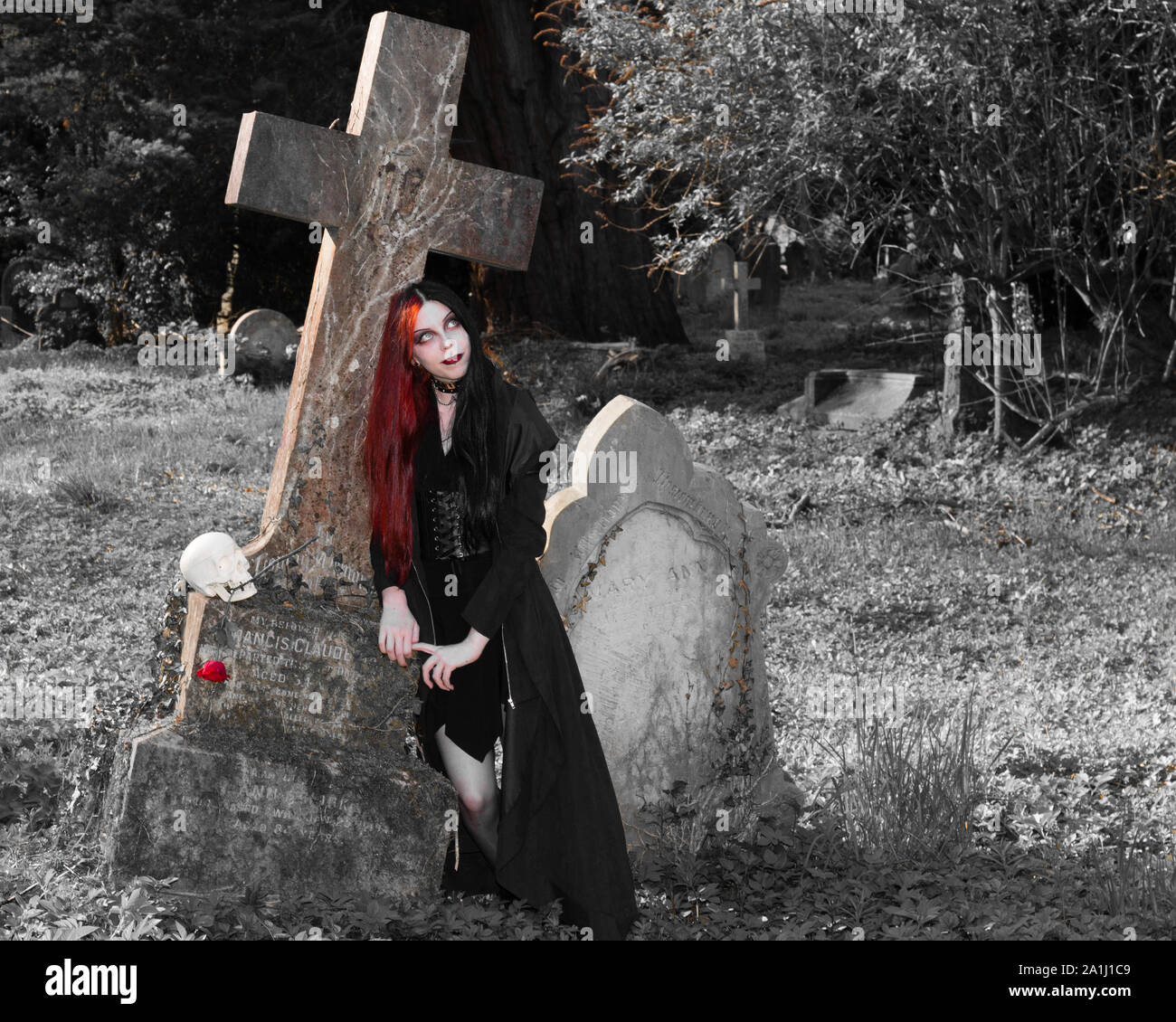 Dark and mysterious young female dressed in black goth costume talks to ...