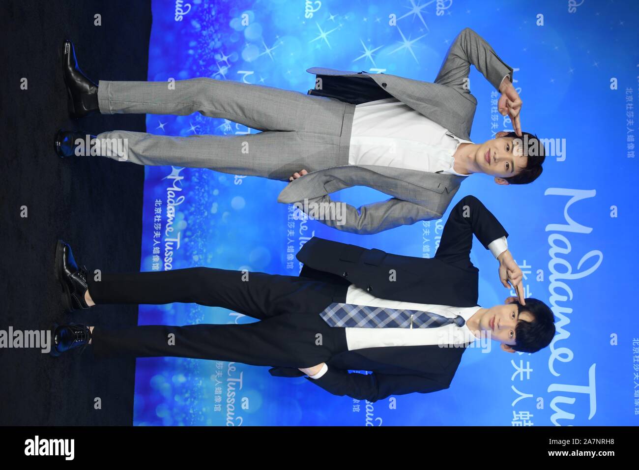 Chinese actor Bai Jingting, left, poses with a wax figure of him during ...