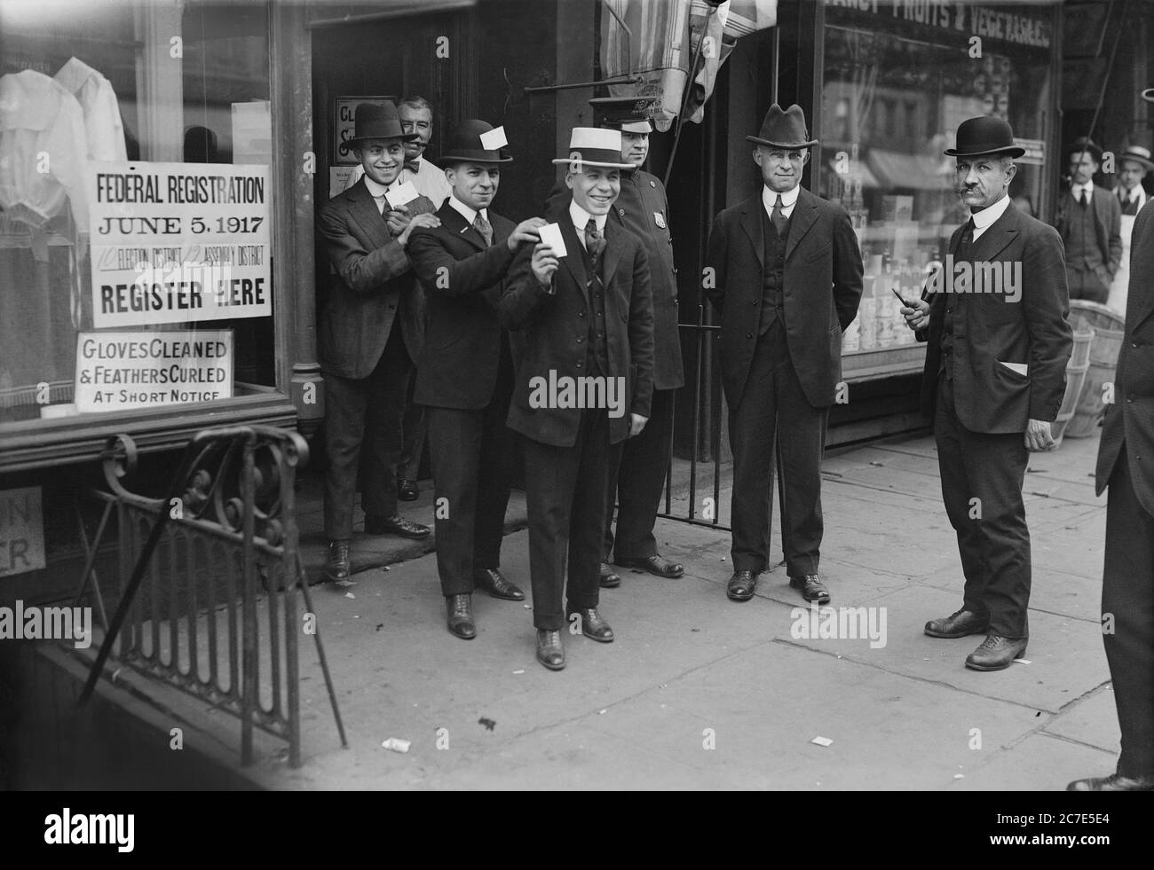 Men holding Draft Cards coming out of Building after registering for ...