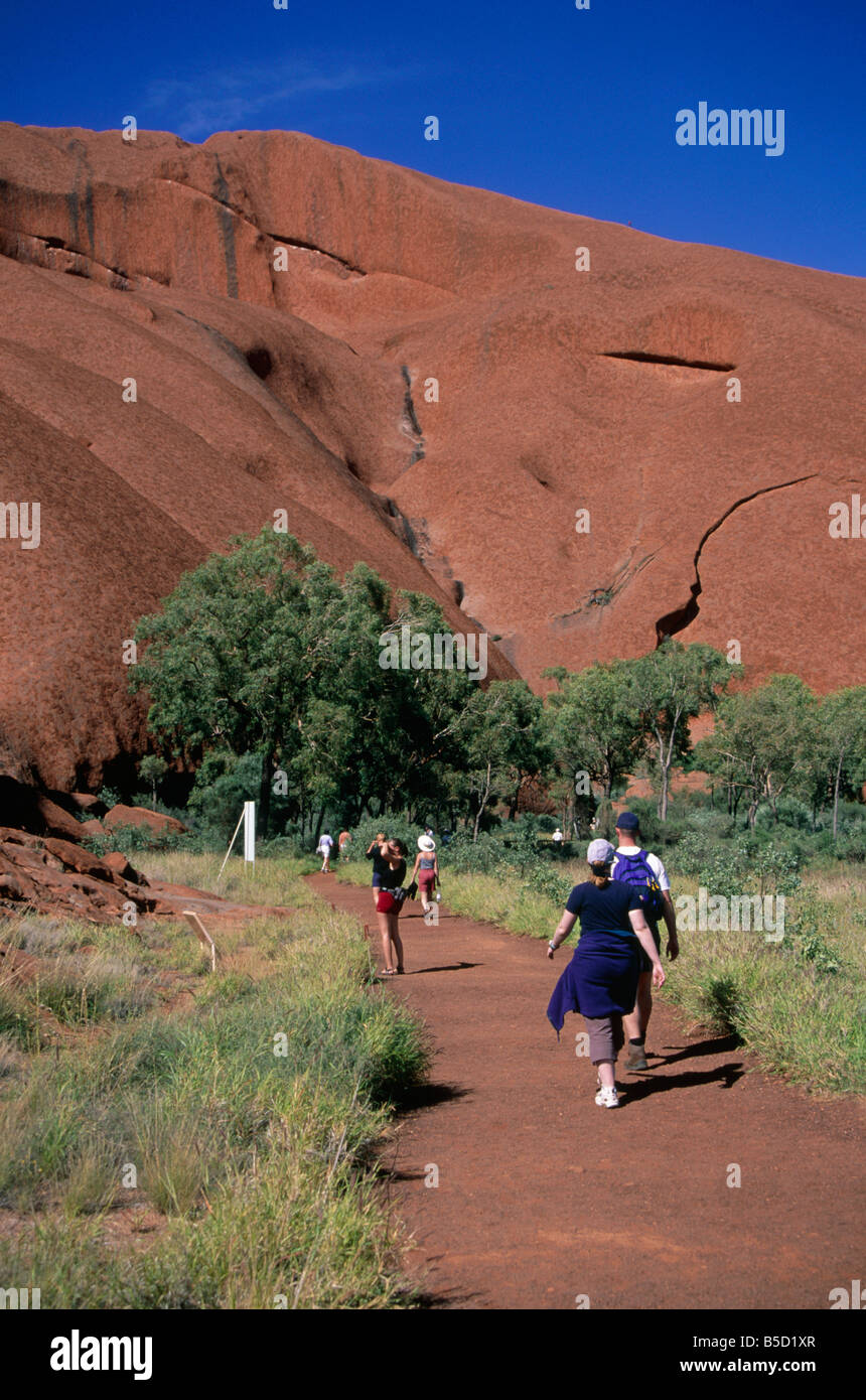 Uluru National Park Huge red sandstone monolith Path People walking ...