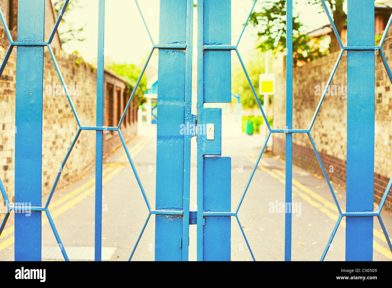 Close up of a locked blue metal school gate Stock Photo - Alamy
