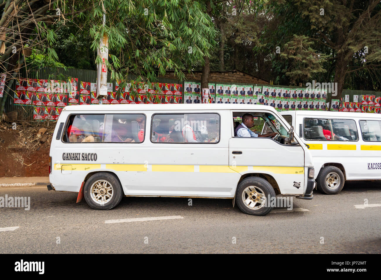 A Matatu Van With Passengers In Front Of A Wall Of Election Posters ...
