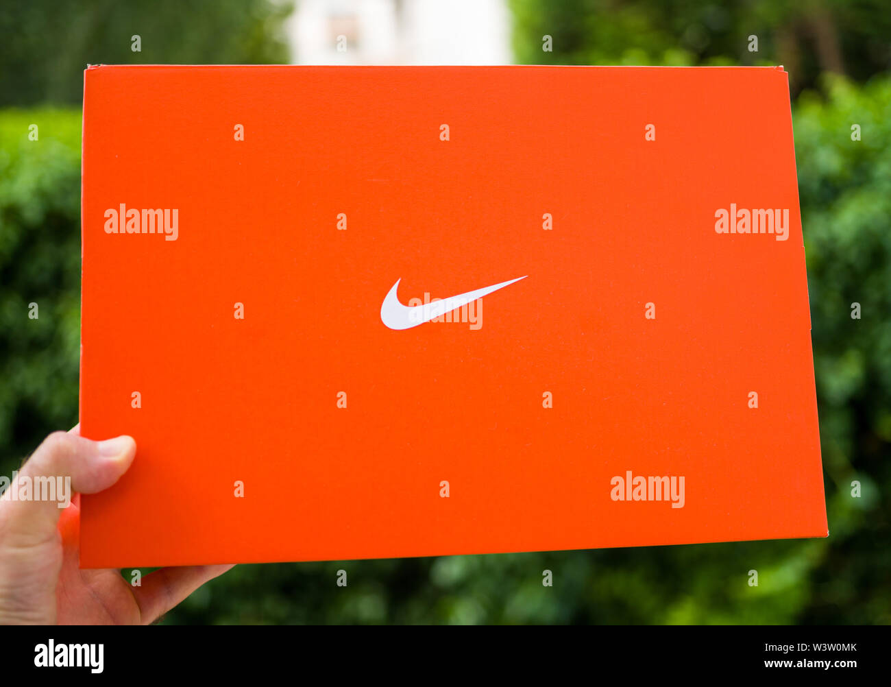 Paris France - Jul 13 2019: Man hand holding new Nike running shoes ...