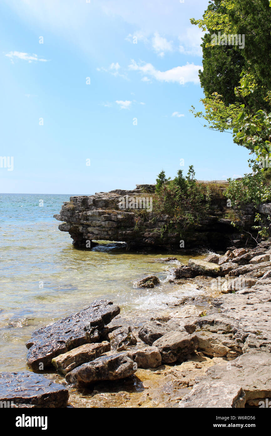 The jagged, rocky shoreline of Lake Michigan in the summer in Cave ...